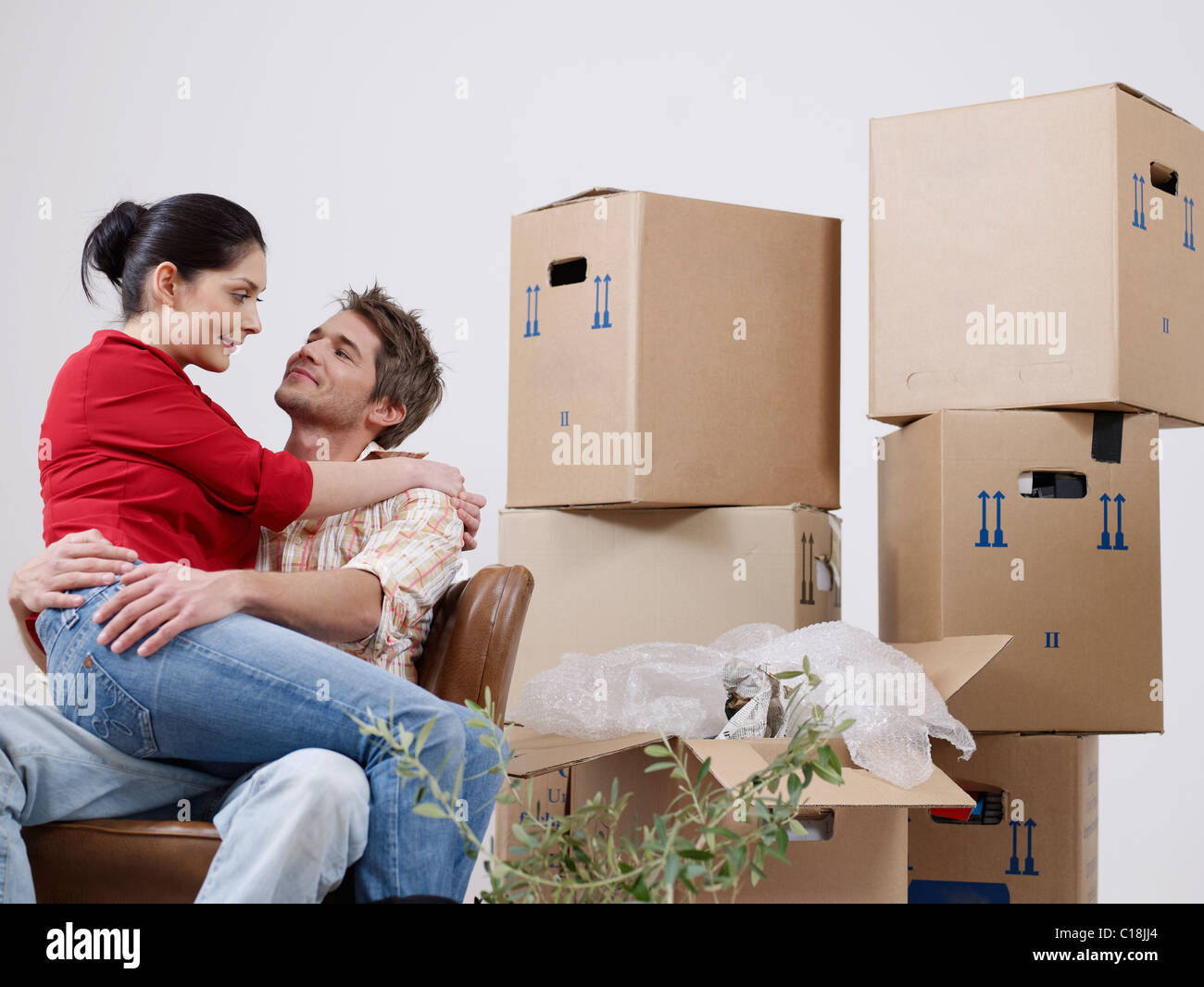 Young couple between packing boxes Stock Photo - Alamy