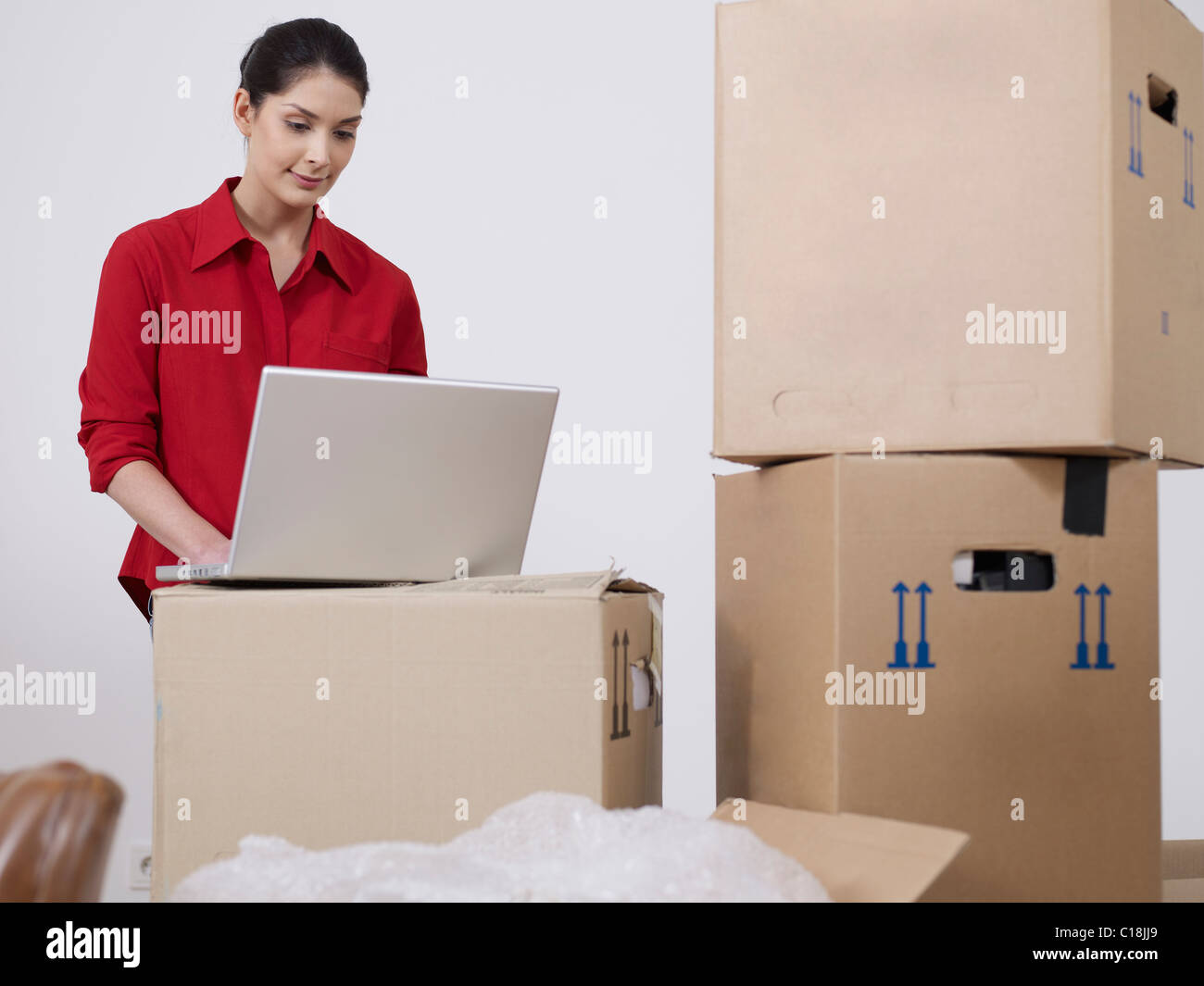 Young women with laptop and boxes Stock Photo - Alamy