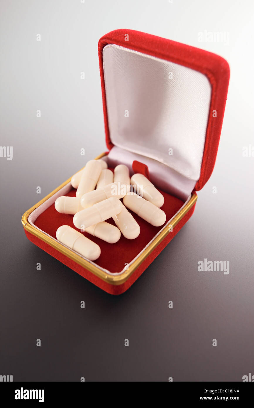 red gift box with capsules Stock Photo - Alamy