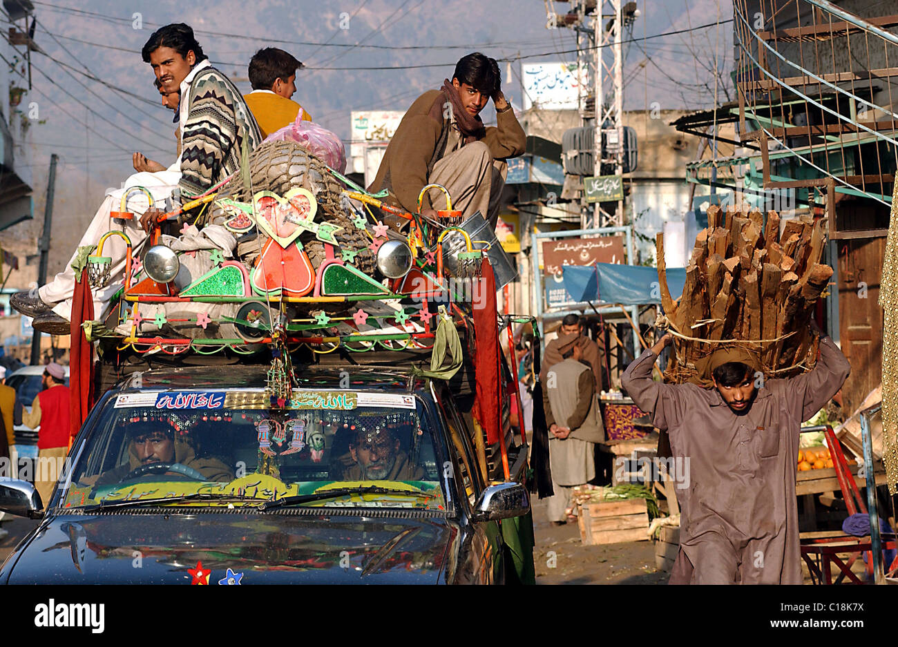 People on top of a car on a street in Pir Baba. Pir Baba, Pakistan ...