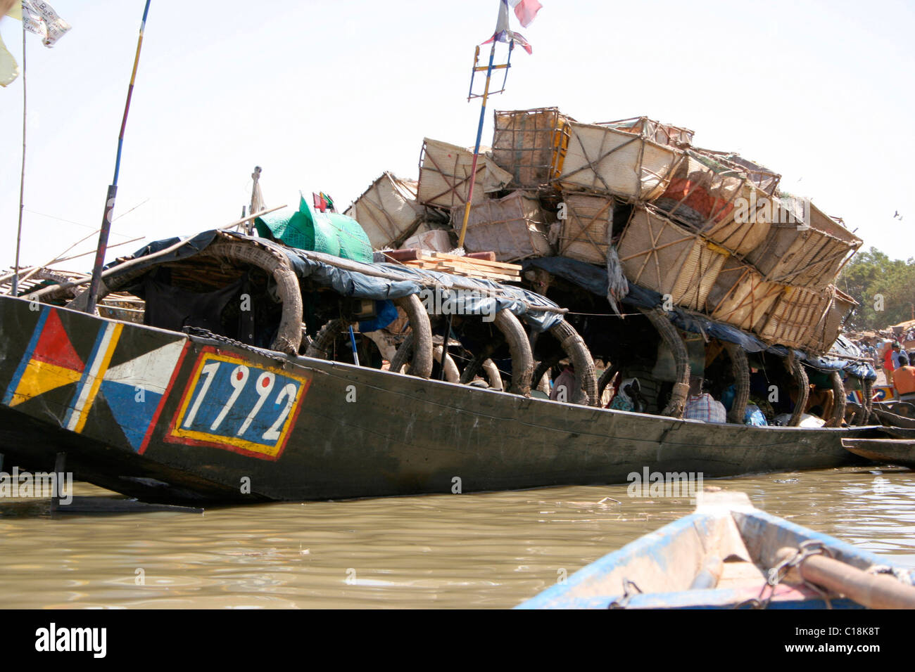 Heavily loaded pinasses in the port of Mopti, in the background the ...