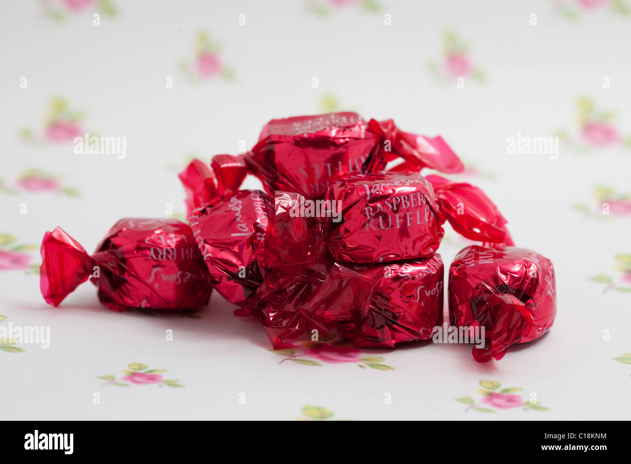 ruffle raspberry sweets and candy on a paper background photographed in ...