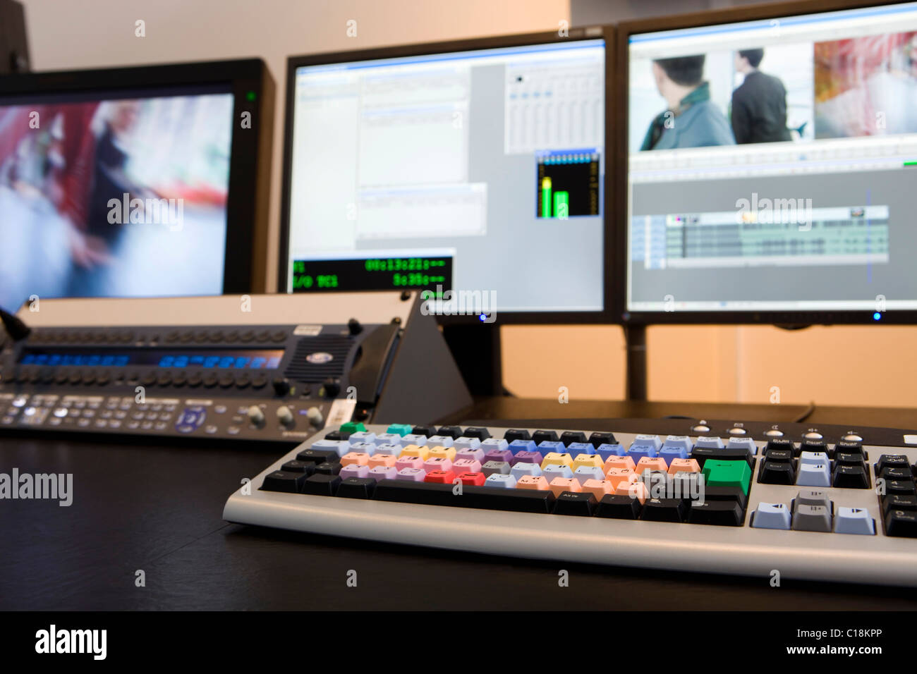 Keyboard in front of screens Stock Photo - Alamy