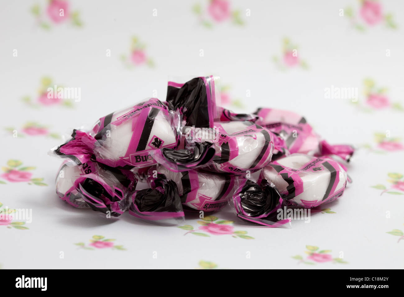 iced caramels sweets and candy on a paper background photographed in a ...