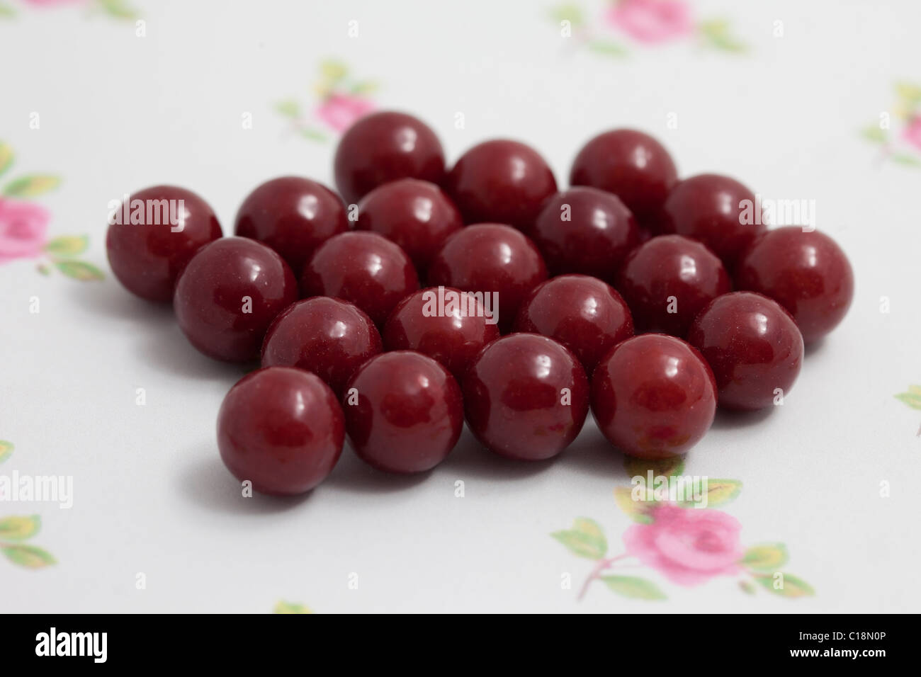 aniseed balls sweets and candy on a paper background photographed in a ...