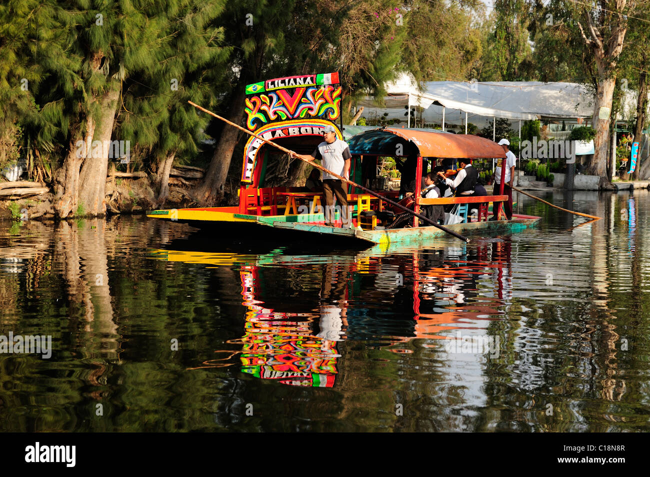 Musicians serenading tourist boat on canal in Xochimilco, Mexico City ...