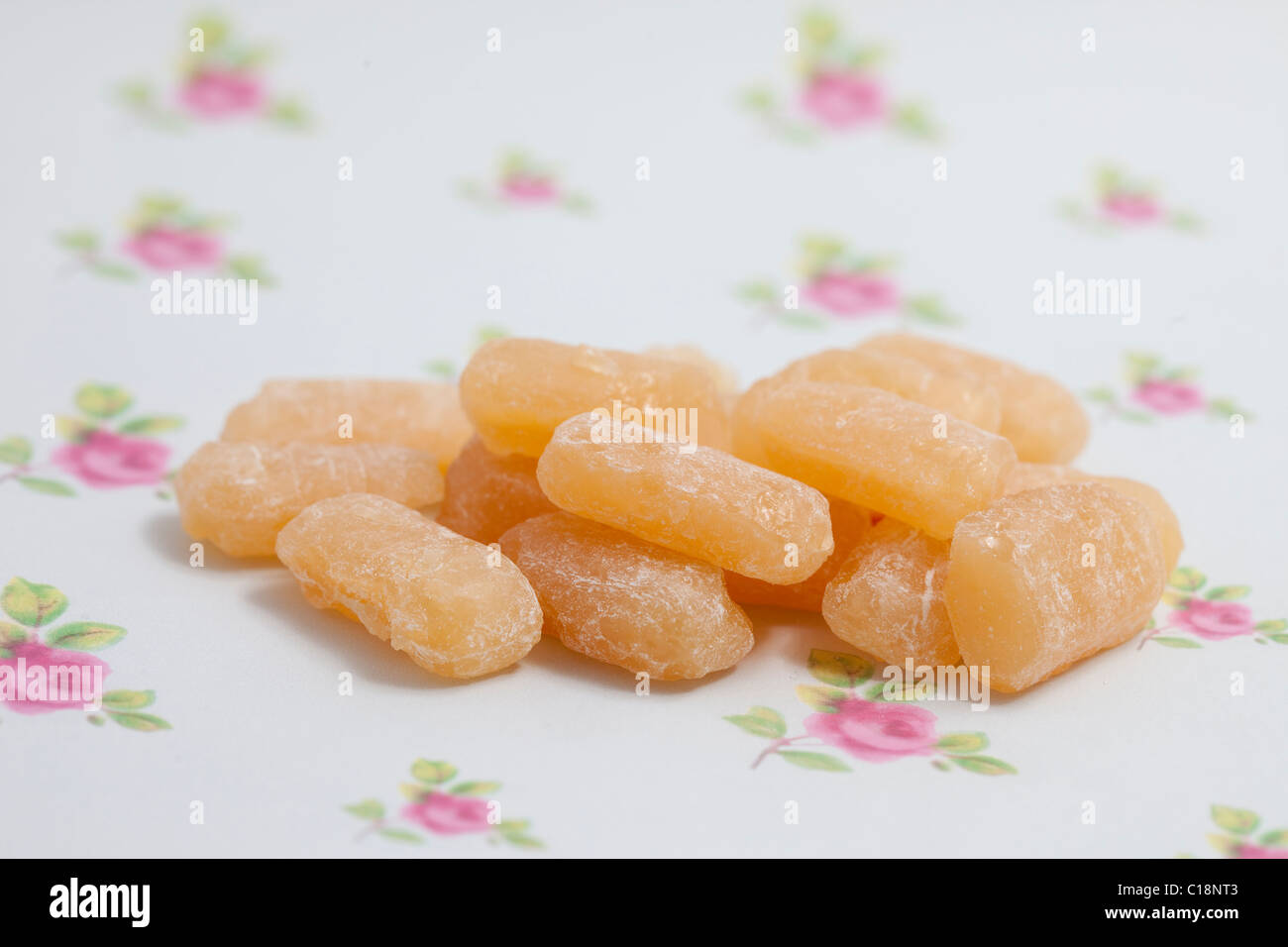 butterscotch sweets and candy on a paper background photographed in a ...