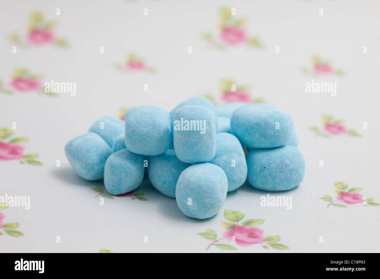 blue raspberry bonbons sweets and candy on a paper background ...