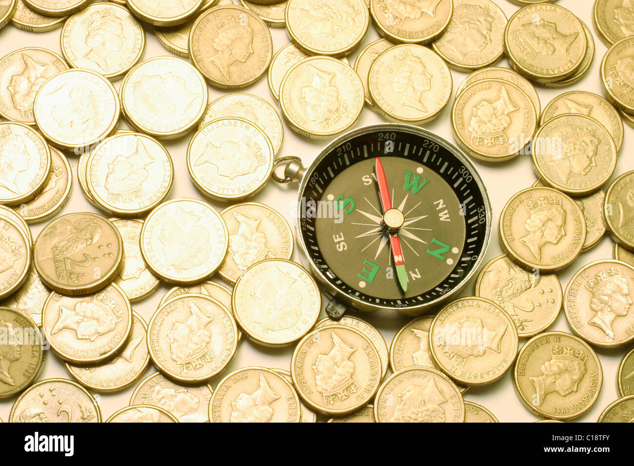 Coins and compass Stock Photo - Alamy