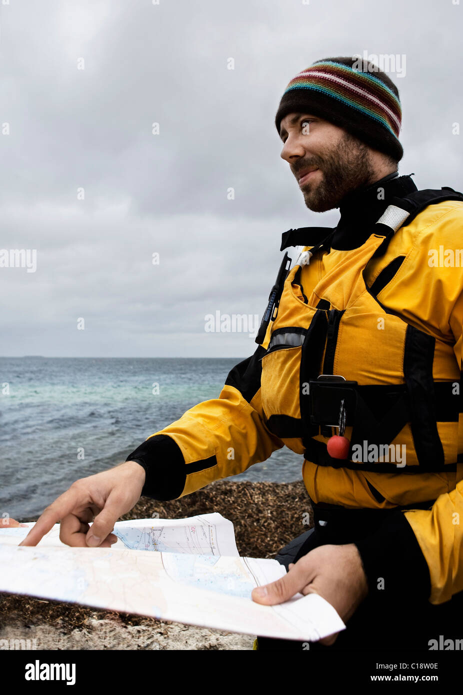 Man looking at map Stock Photo - Alamy