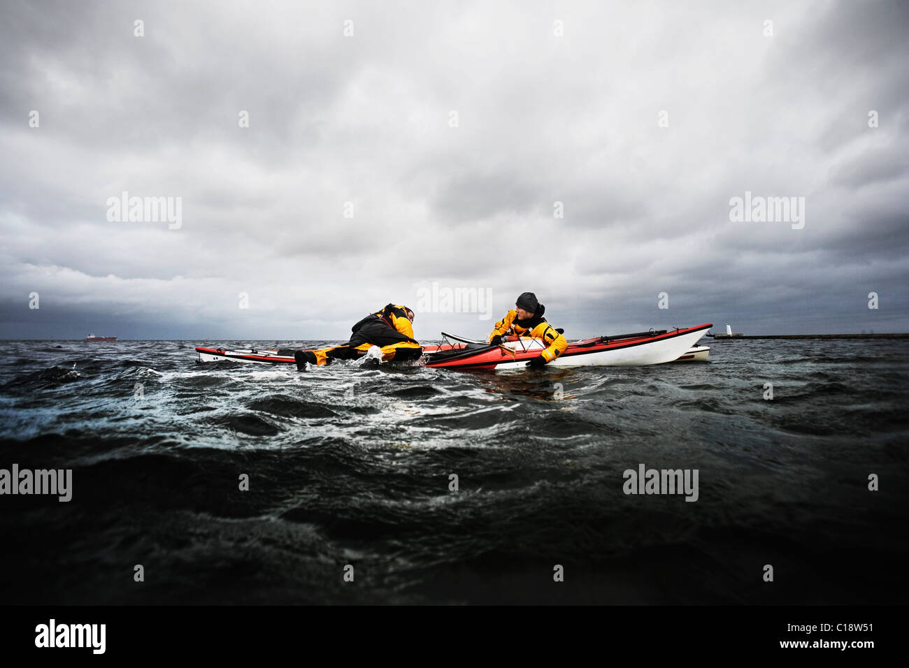 Friends in kayak helping each other Stock Photo - Alamy