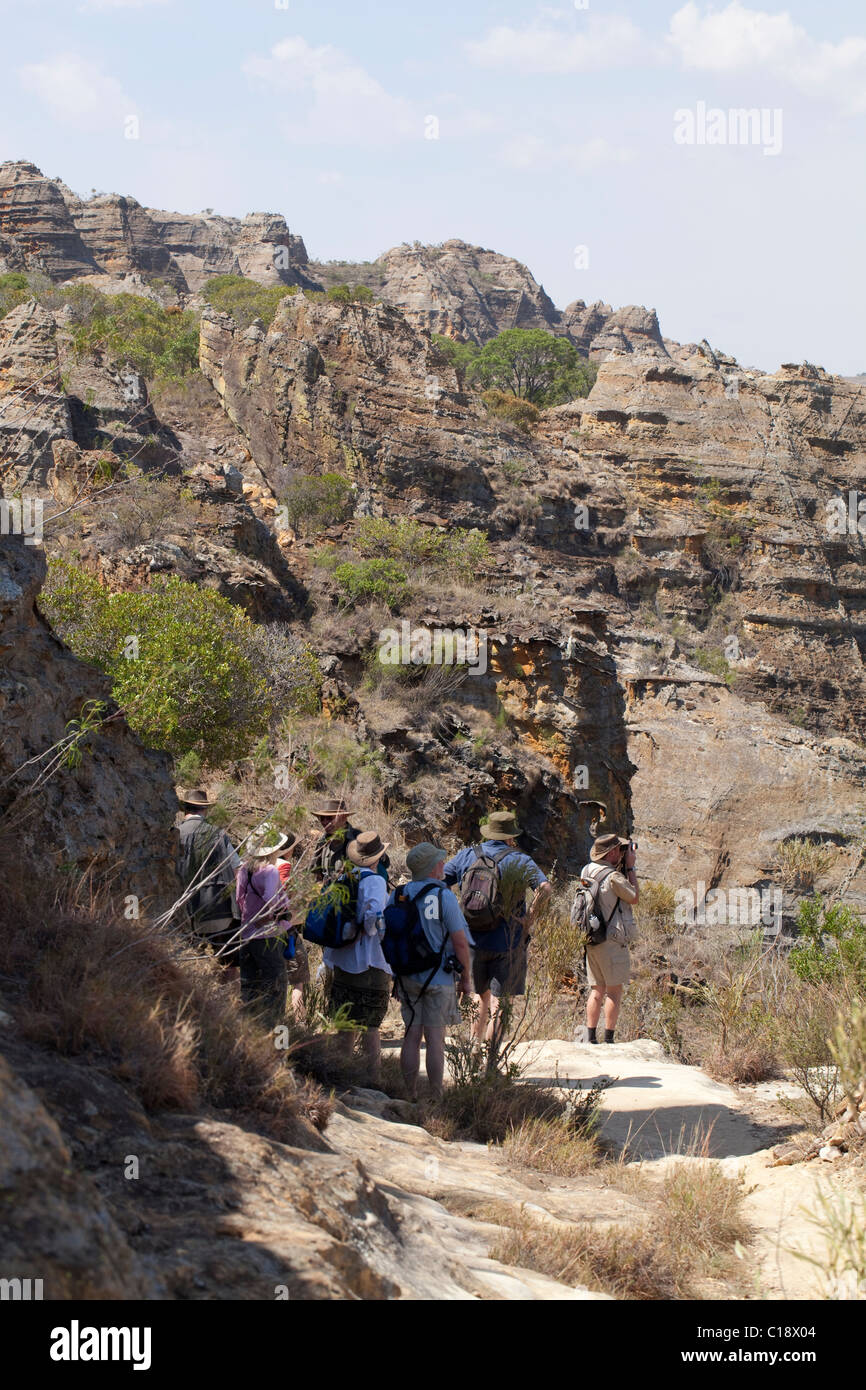 Tourists having a break whilst trekking through Isalo National Park ...