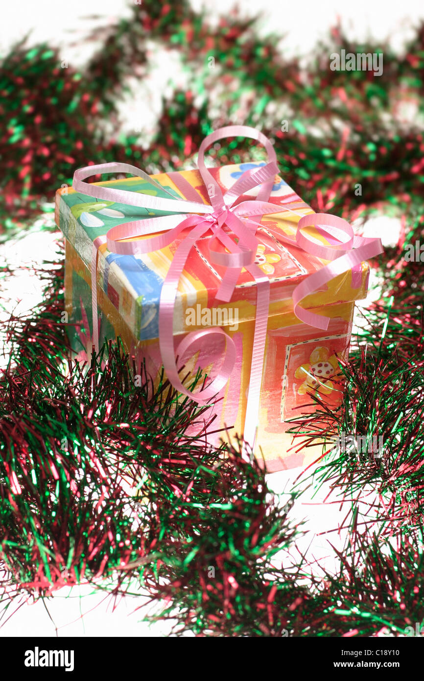 Gift box and christmas tinsel Stock Photo - Alamy