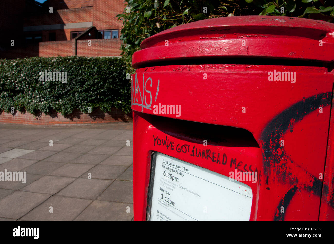 Red post box with graffiti about e mail/text You have 1 unread Message ...