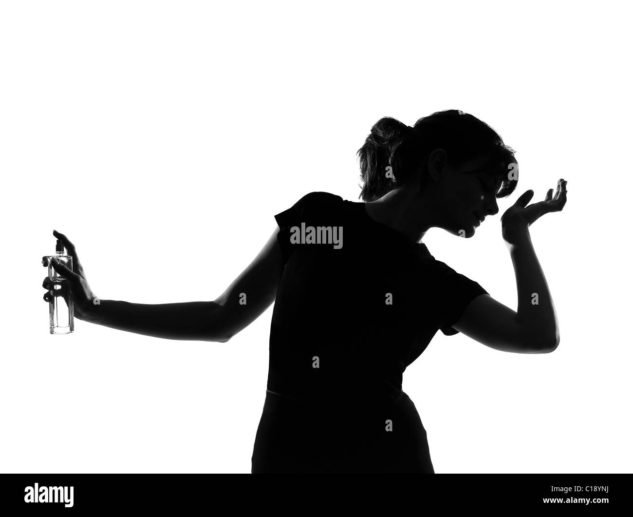 portrait silhouette in shadow of a one young woman smelling perfume in ...