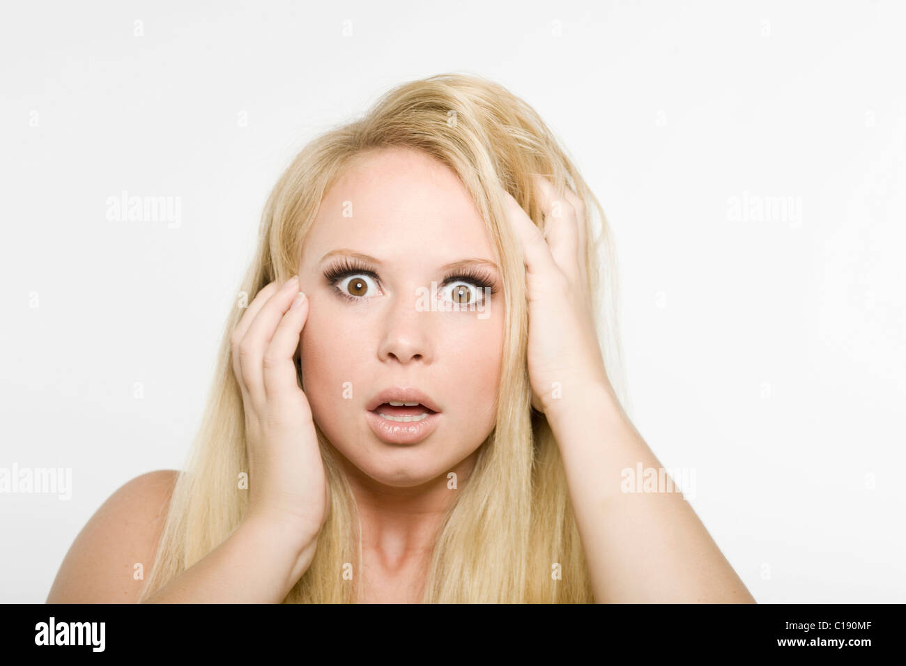 Young blonde woman, shocked expression Stock Photo - Alamy