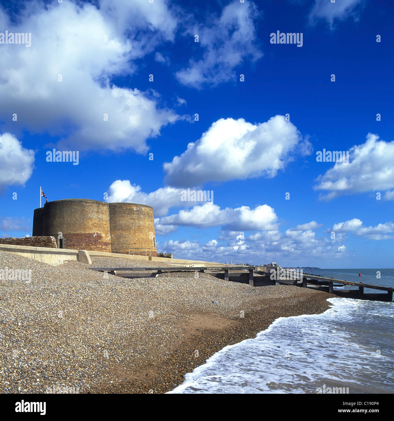 North Sea washes onto the pebble beach at Aldeburgh with Martello Tower ...