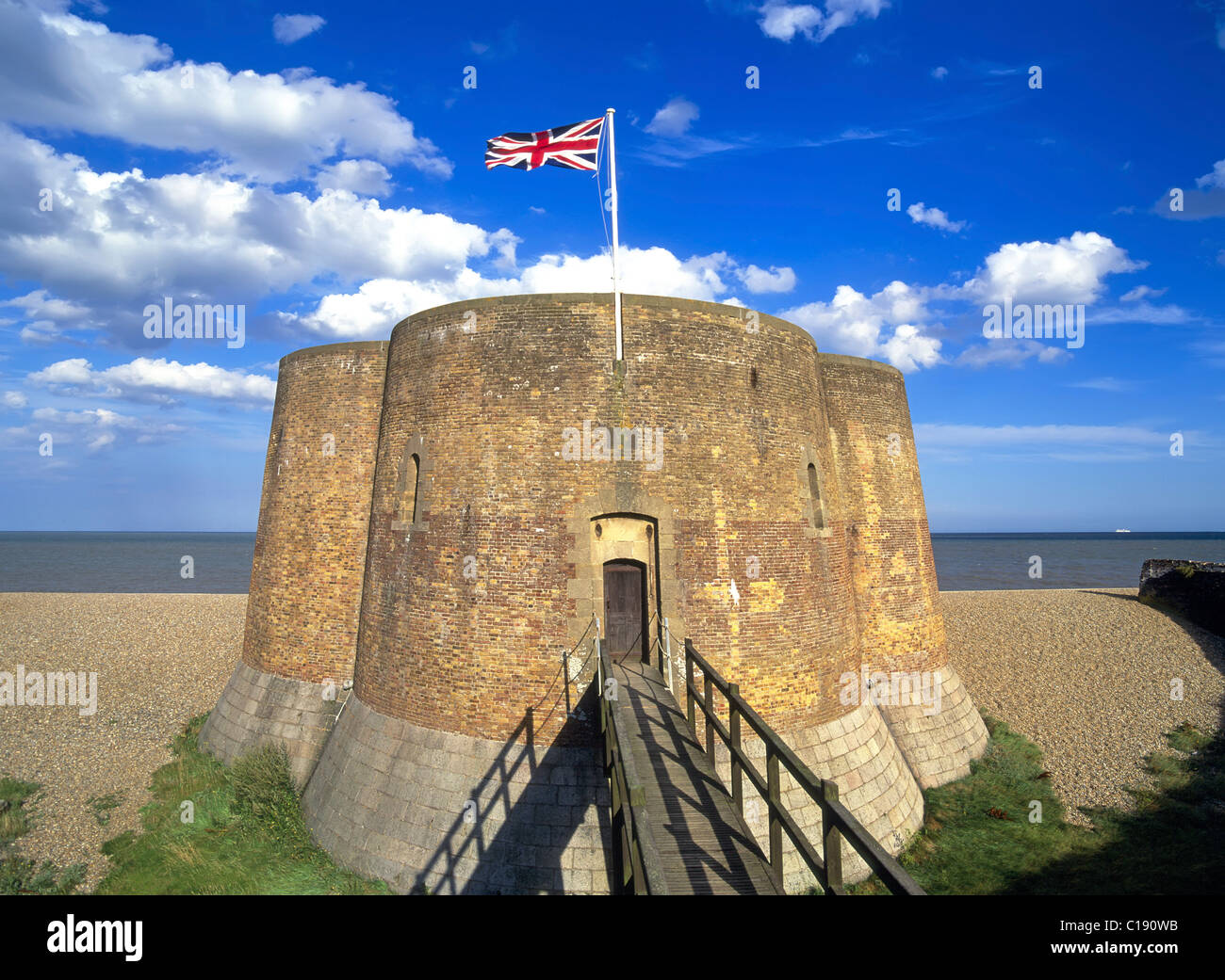 Historical Martello Tower building & footbridge union jack flag pebble ...