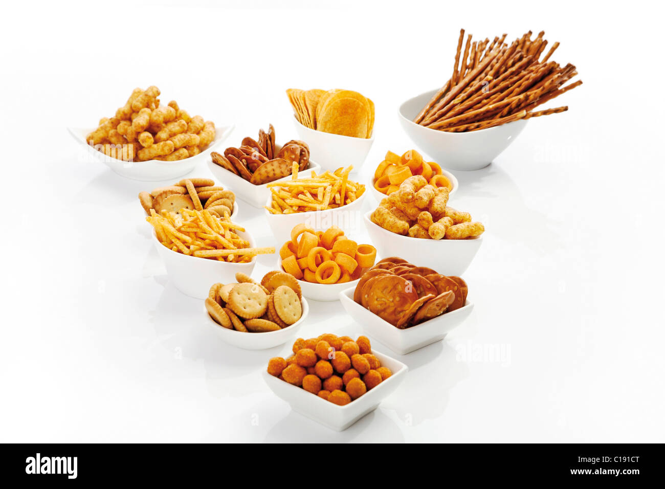 Various spiced snacks in bowls, crisps, peanut flips, pretzel sticks ...