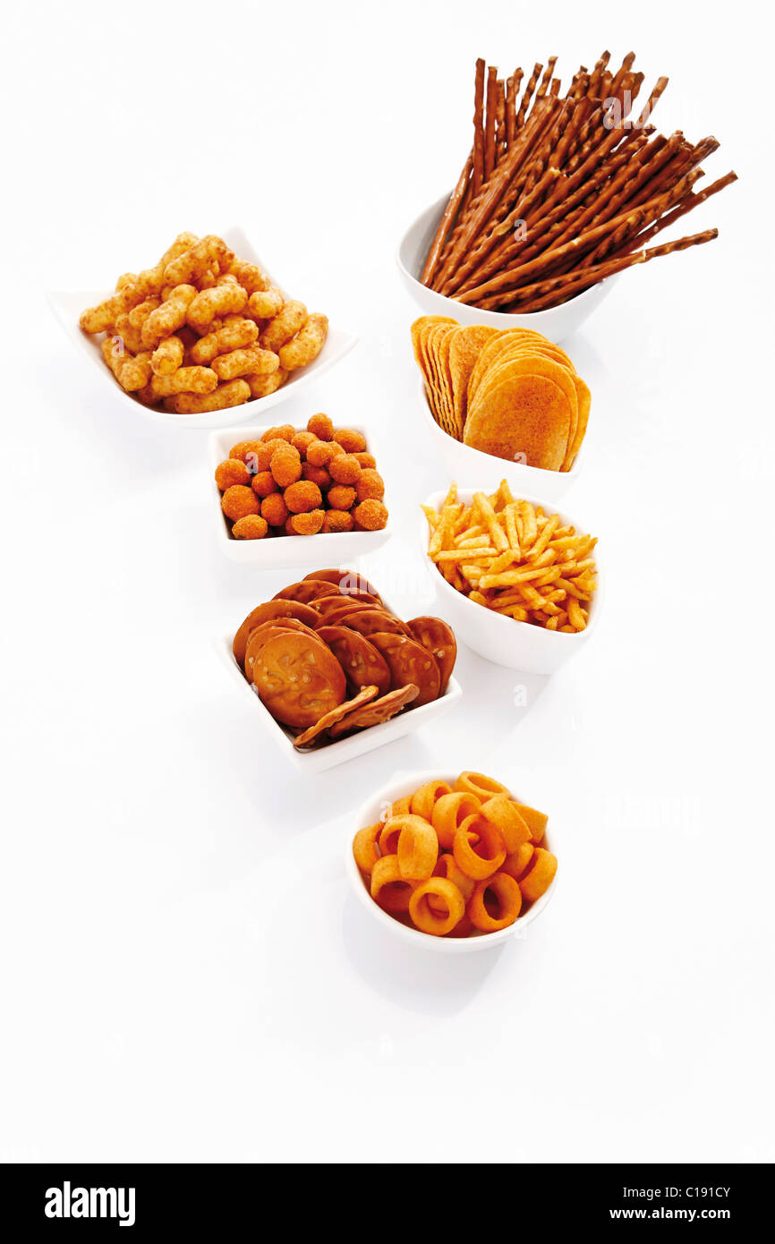 Various spiced snacks in bowls, crisps, peanut flips, pretzel sticks ...