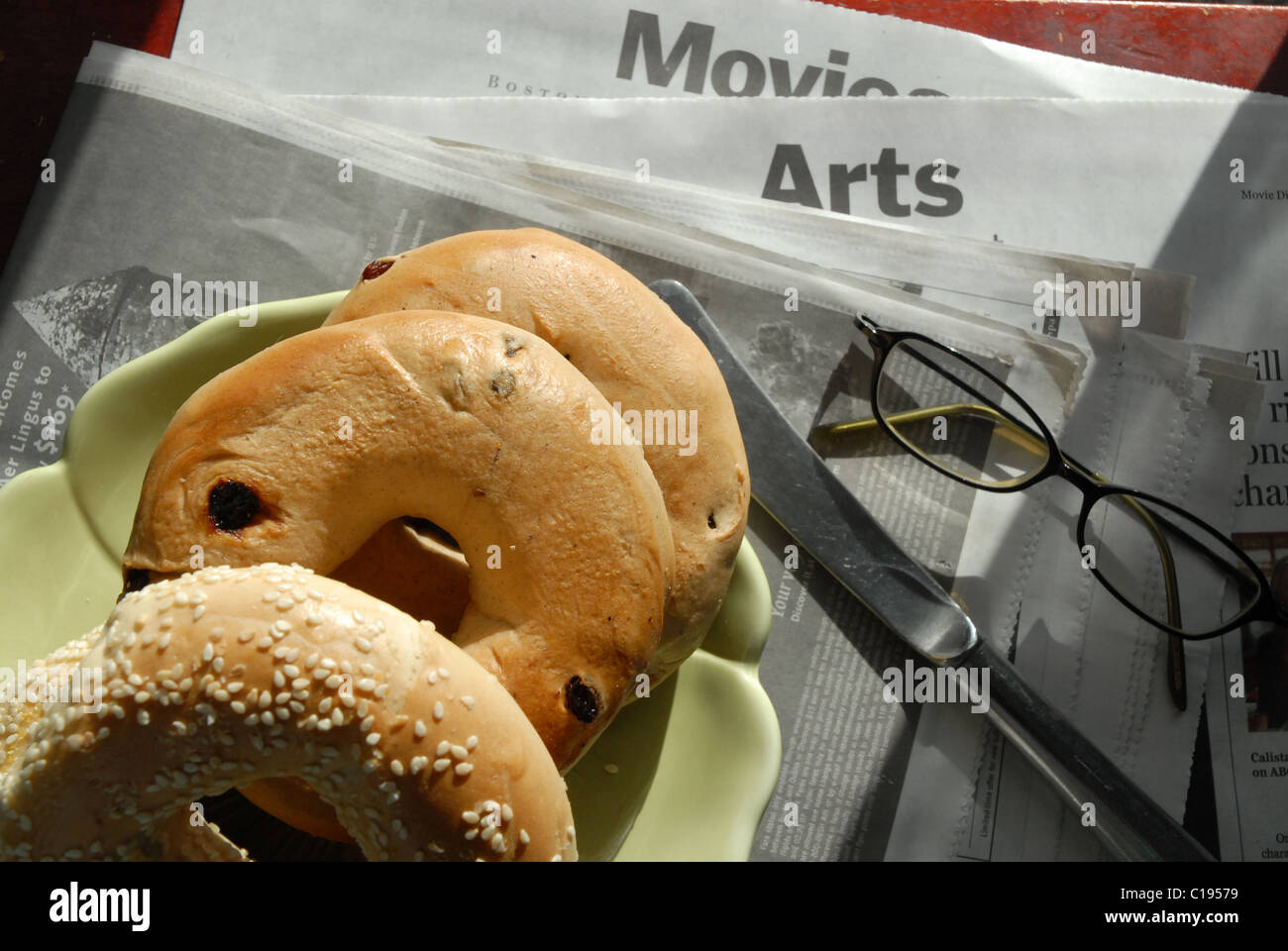 Plate of bagels with newspapers and reading glasses Stock Photo - Alamy