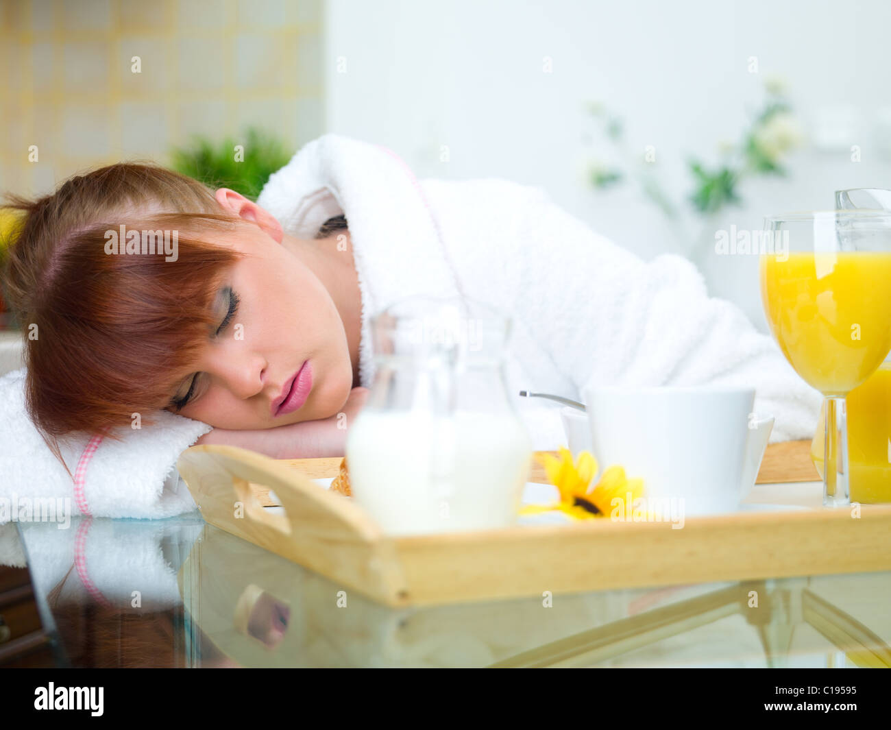 Beautiful woman in kitchen sleeping on table Stock Photo - Alamy