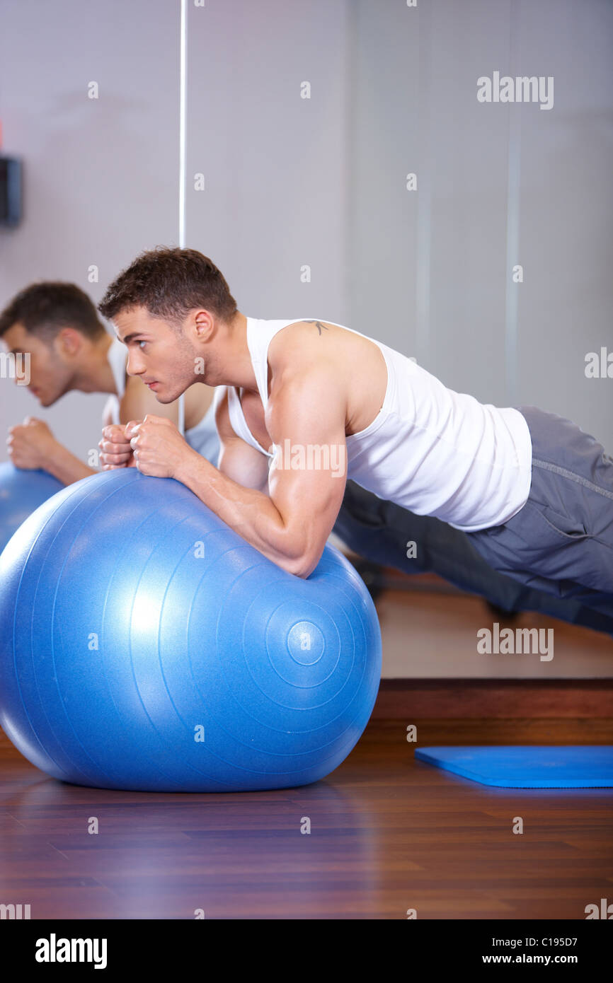 Handsome man at the gym doing exercises Stock Photo - Alamy