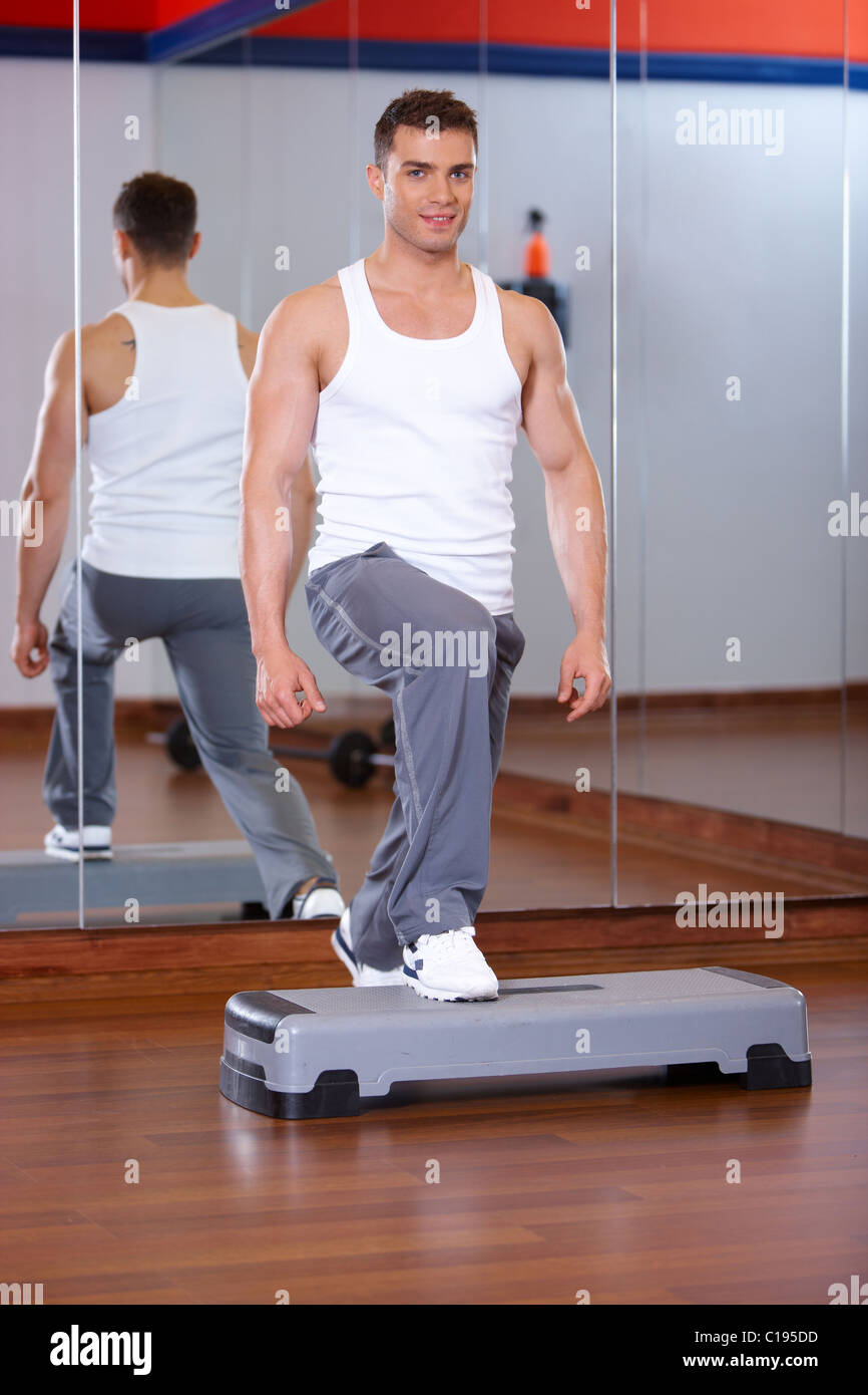 Handsome man at the gym doing exercises Stock Photo - Alamy