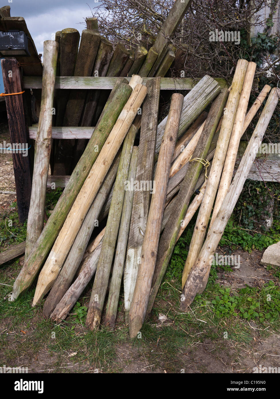 Pile of fence posts on farm Stock Photo - Alamy