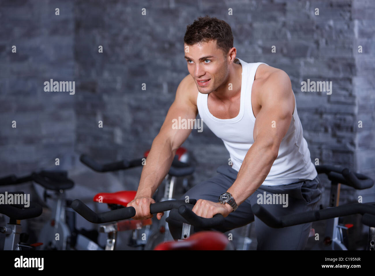 Handsome man at the gym doing exercises Stock Photo - Alamy