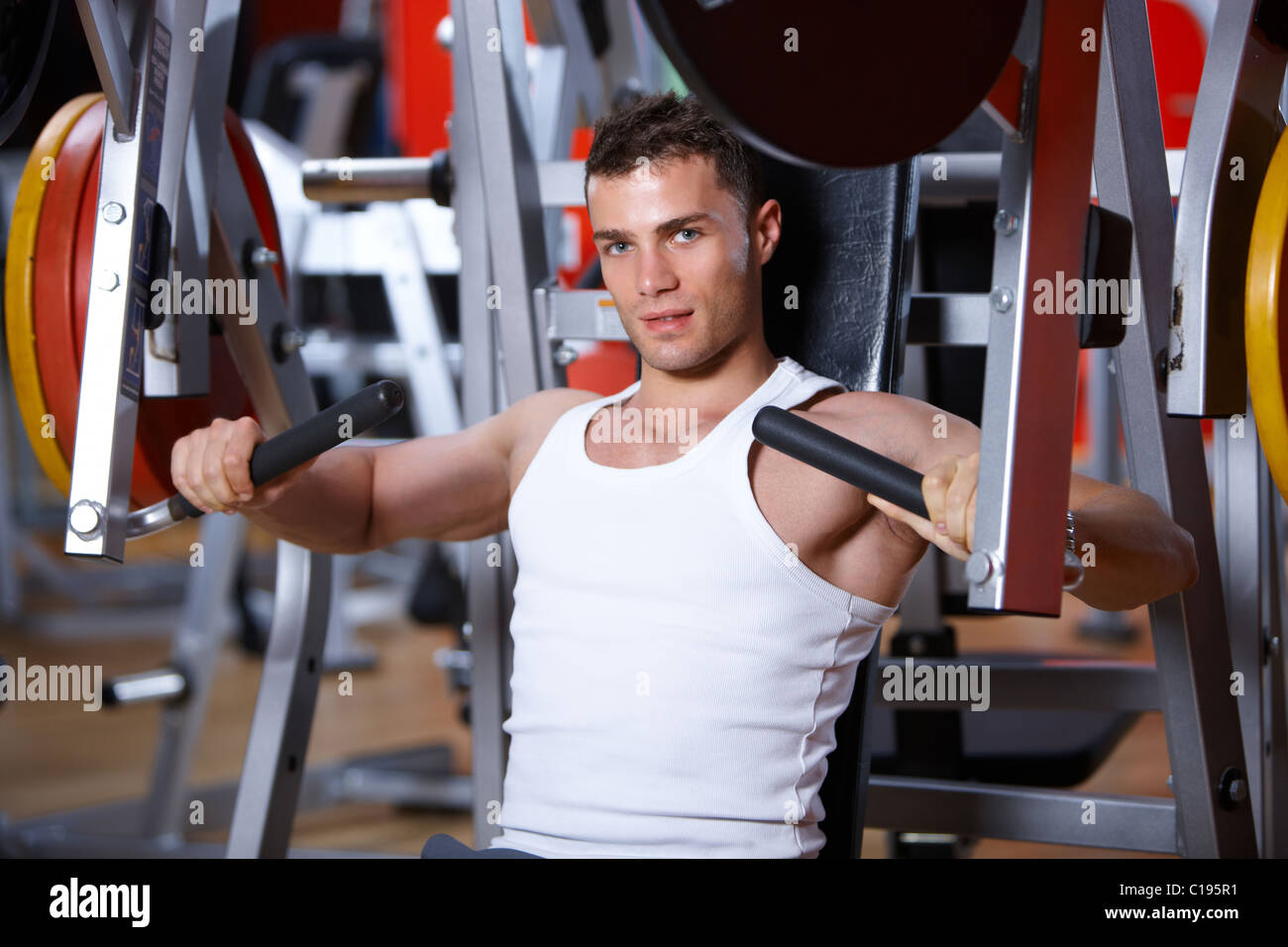 Handsome man at the gym doing exercises Stock Photo - Alamy