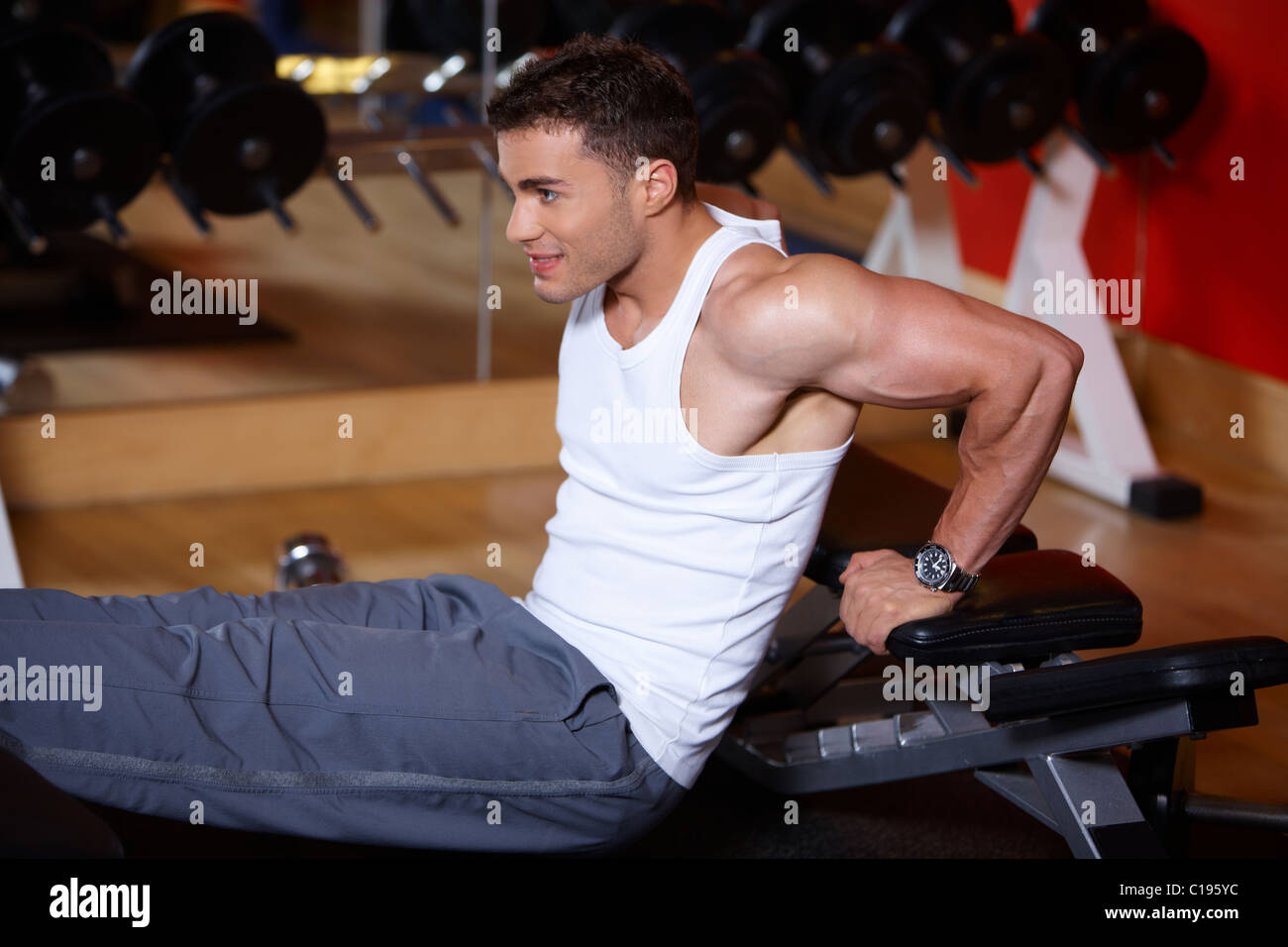 Handsome man at the gym doing exercises Stock Photo - Alamy