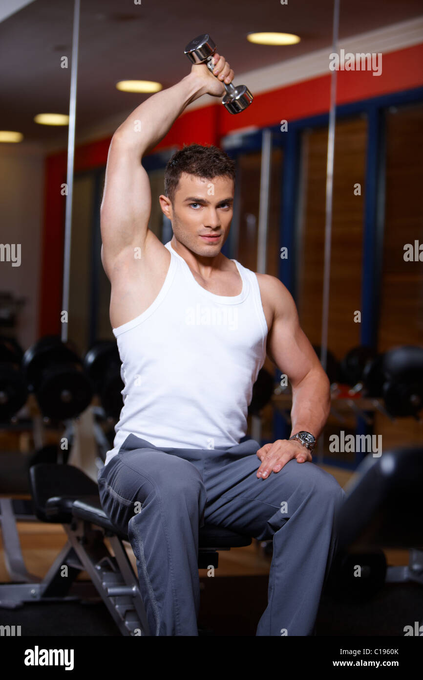 Handsome man at the gym doing exercises Stock Photo - Alamy