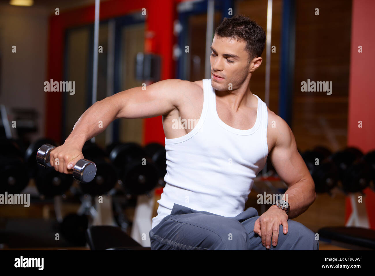 Handsome man at the gym doing exercises Stock Photo - Alamy