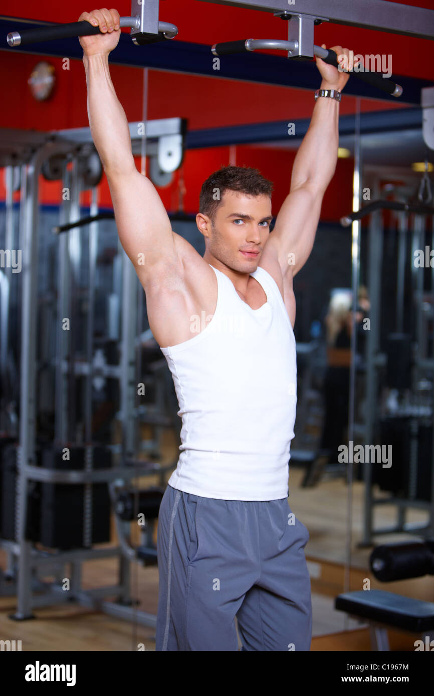 Handsome man at the gym doing exercises Stock Photo - Alamy