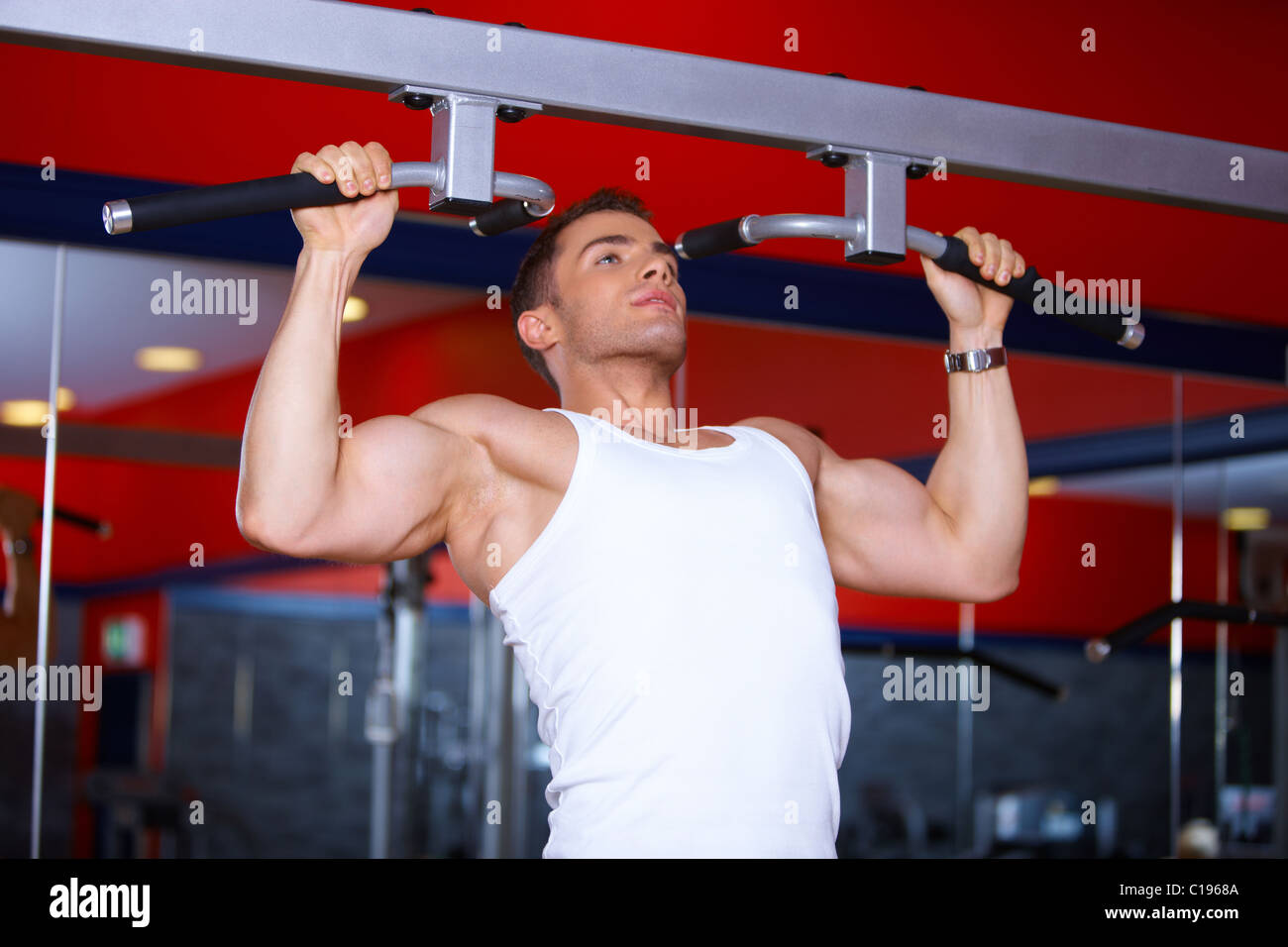 Handsome man at the gym doing exercises Stock Photo - Alamy
