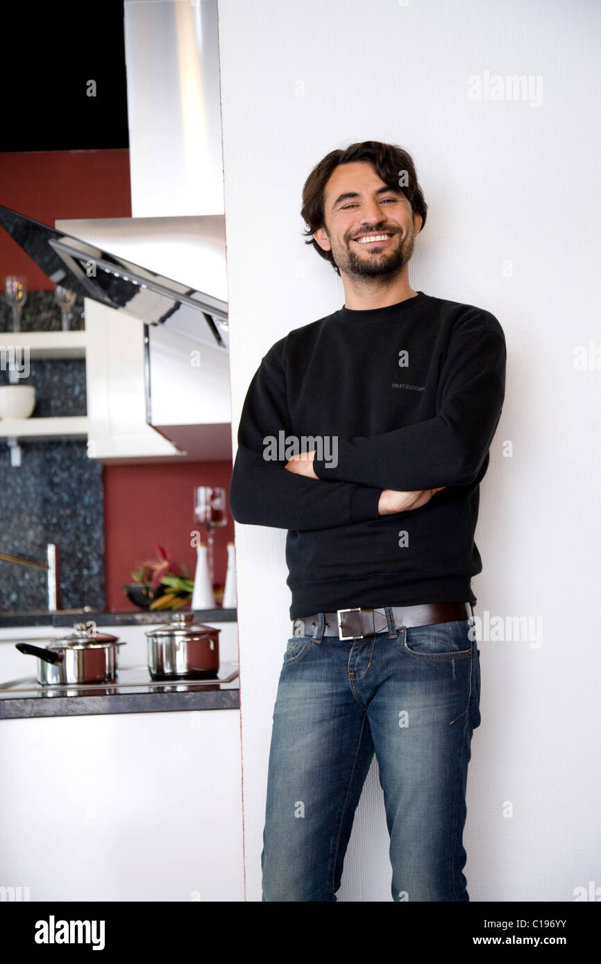 Man standing in his new kitchen Stock Photo - Alamy