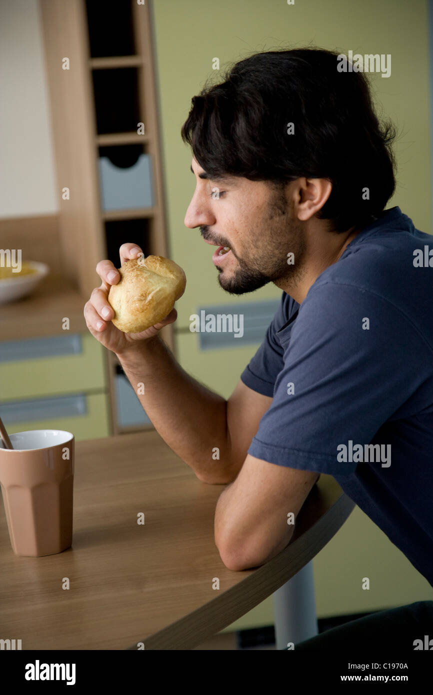 Man eating a roll Stock Photo - Alamy