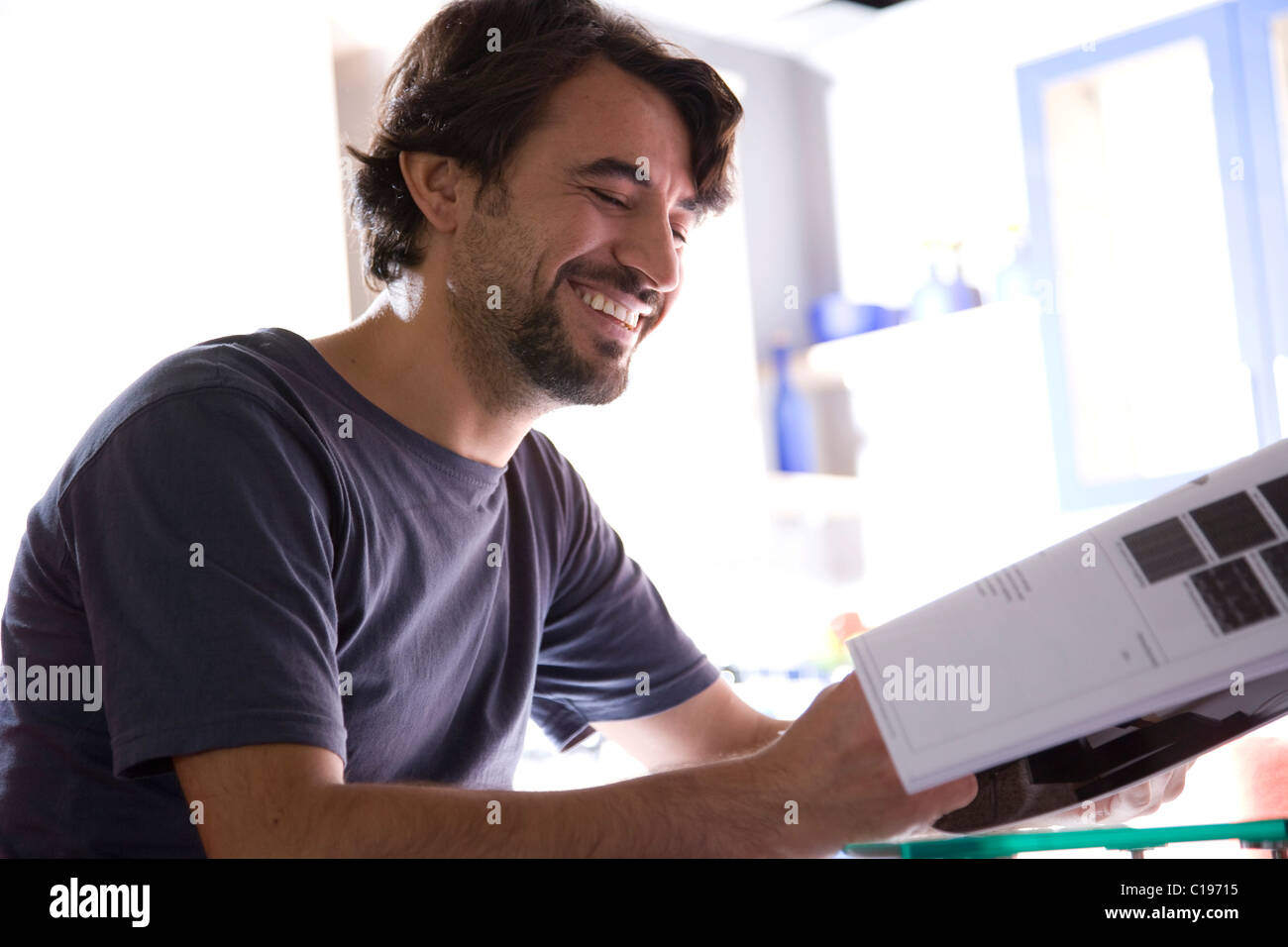 Man reading a leaflet Stock Photo - Alamy
