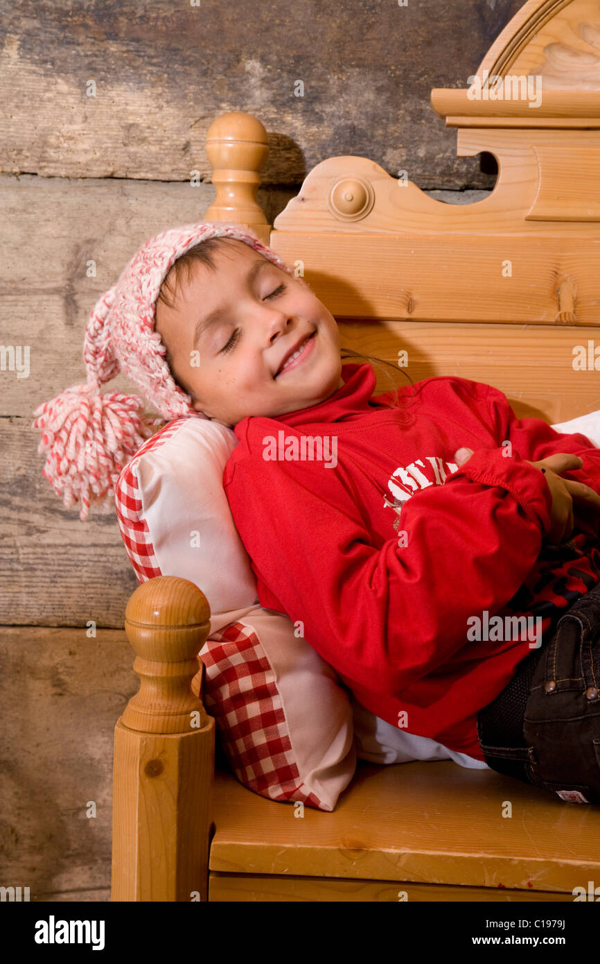 Boy sleeping on an old bench Stock Photo - Alamy