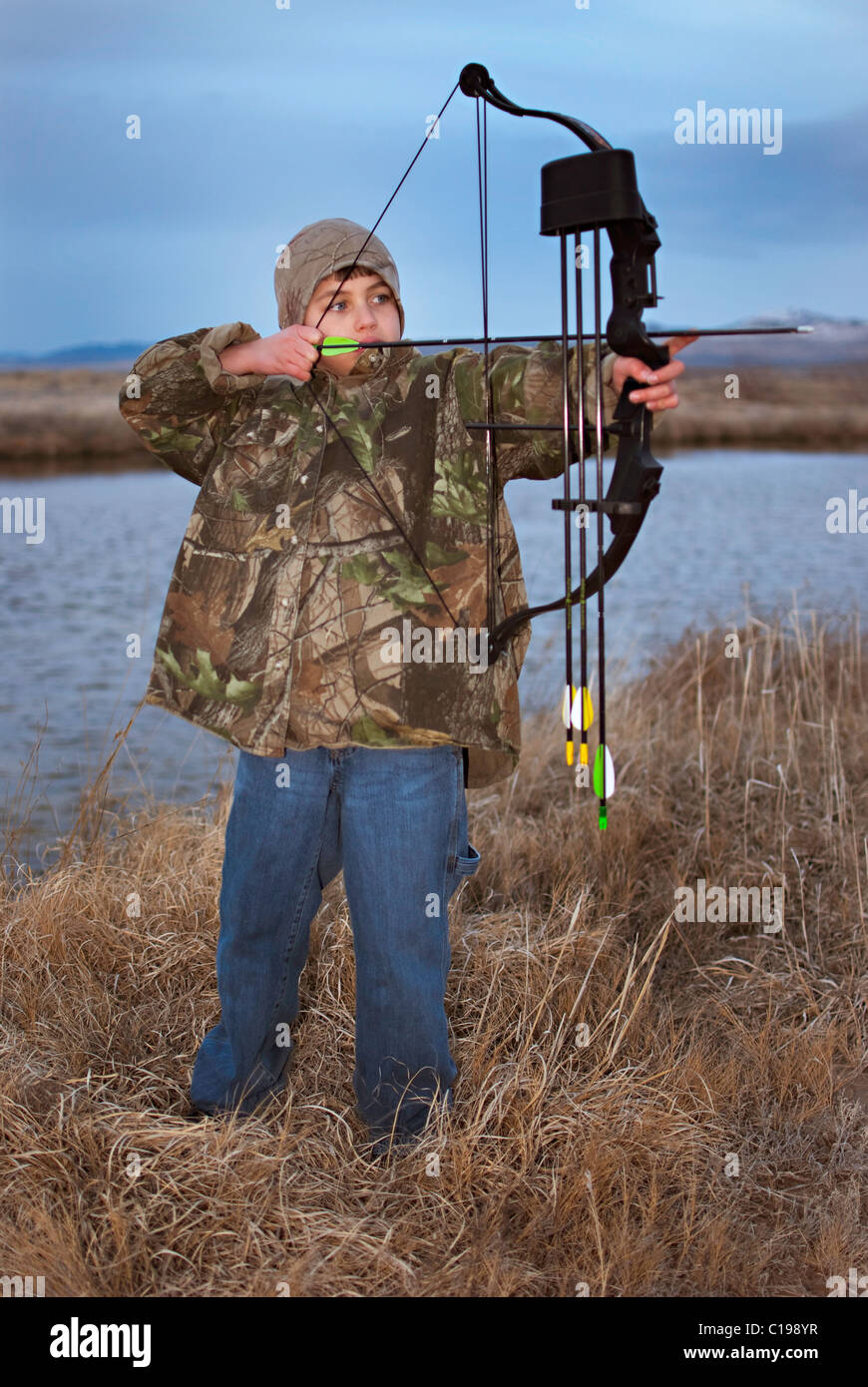 A young boy bowhunting Stock Photo - Alamy