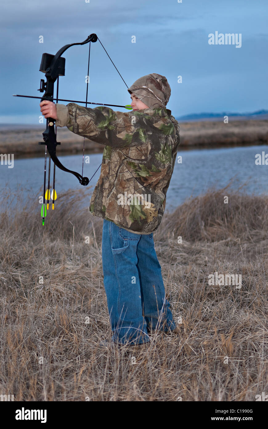 A young boy bowhunting Stock Photo - Alamy
