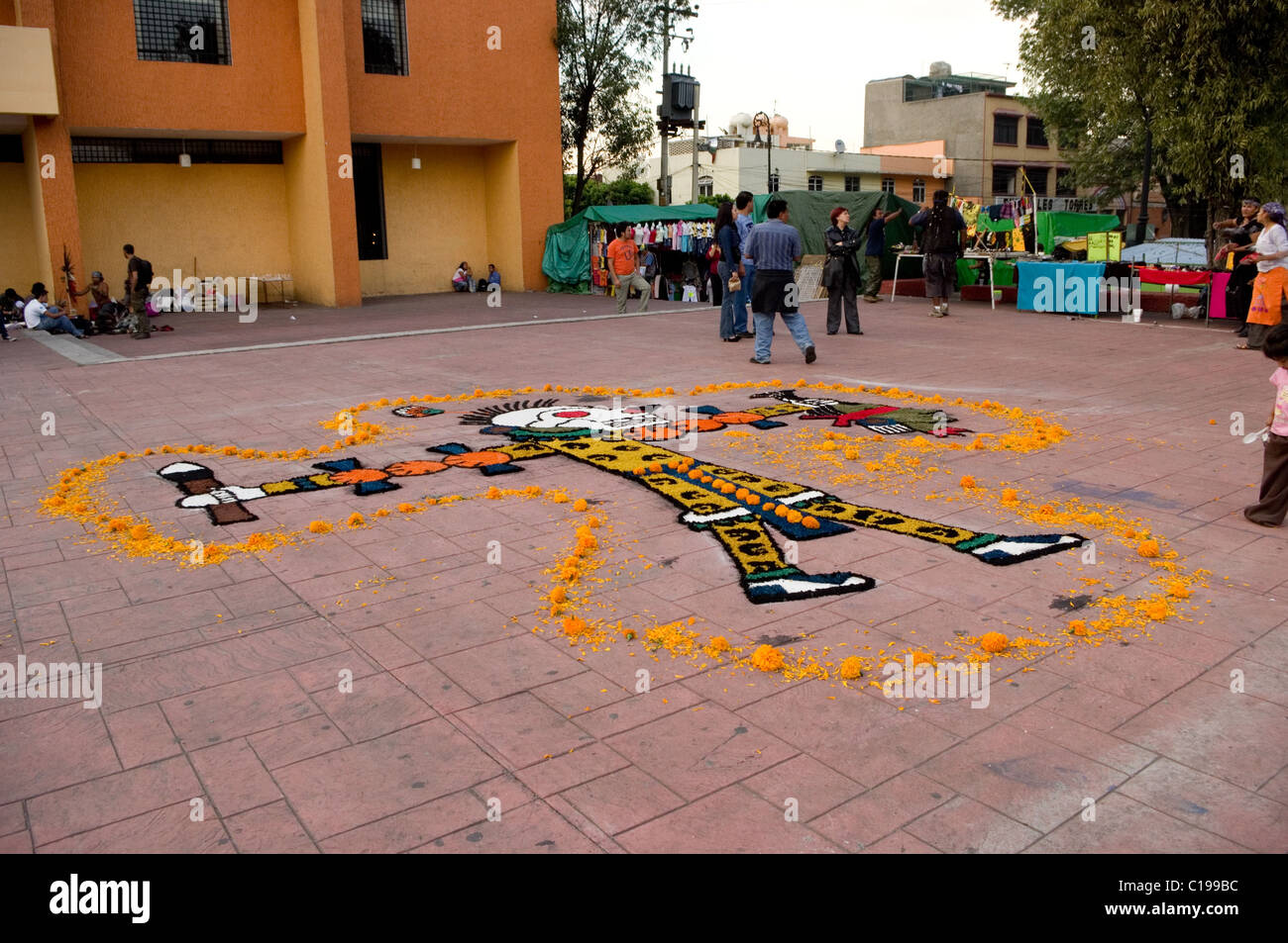 Drawing made with colored sand and flowers representing an Aztec ...