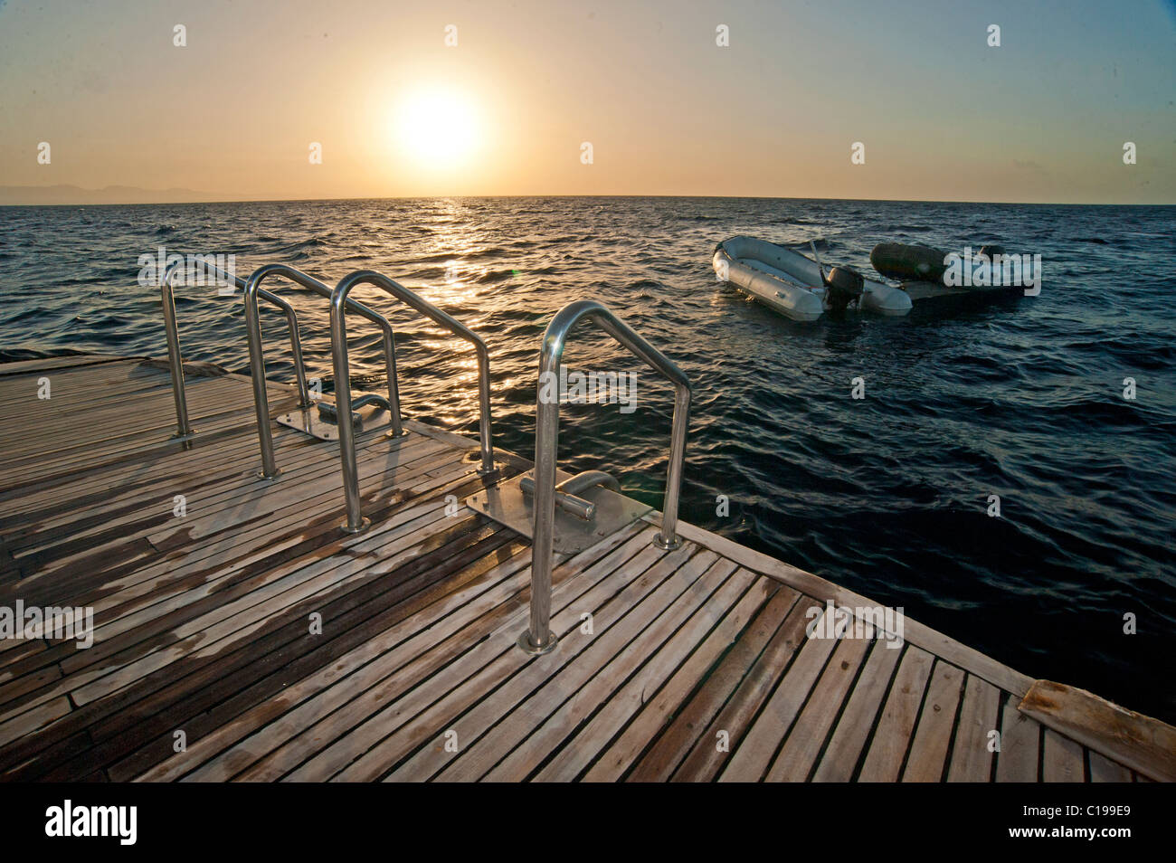 View off the back of a large motor yacht with two small tender boats at ...