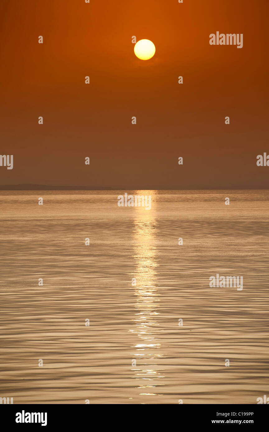 Orange sunset over an ocean landscape Stock Photo - Alamy