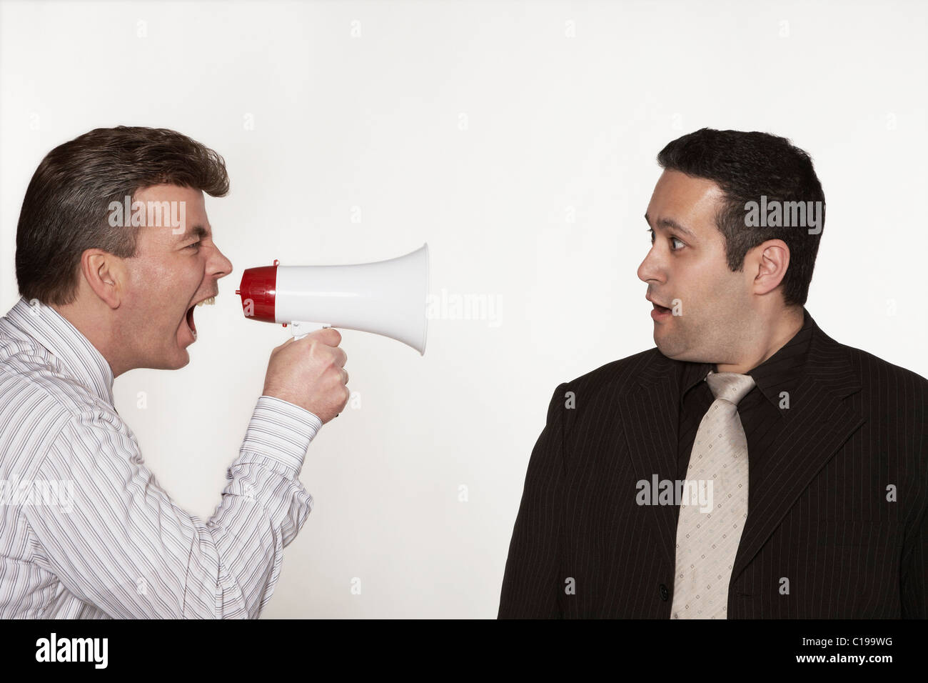 Businessman yelling orders to his colleague through a megaphone Stock ...