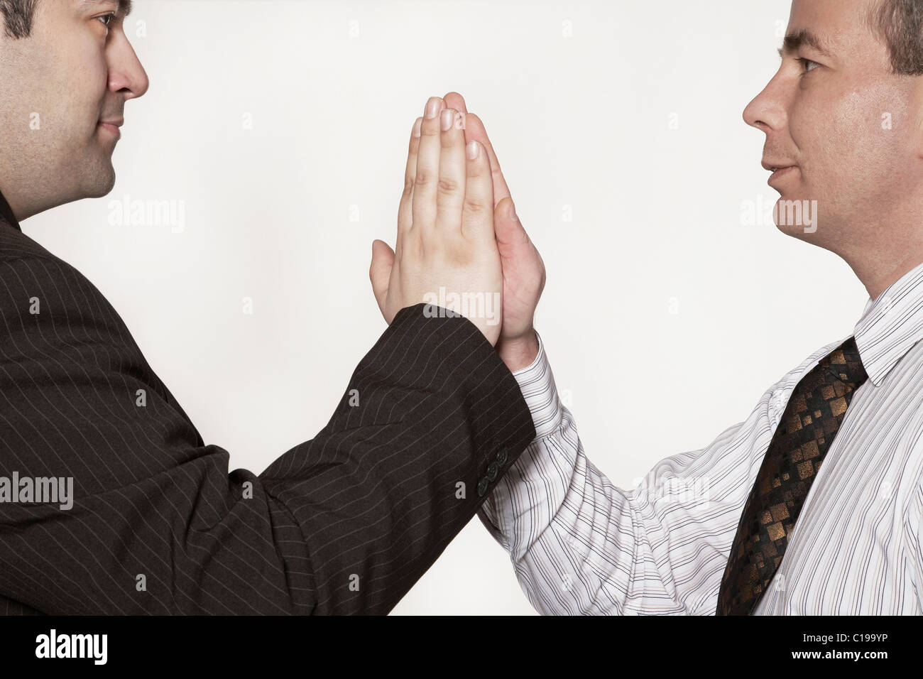 Two businessmen doing a high five Stock Photo - Alamy
