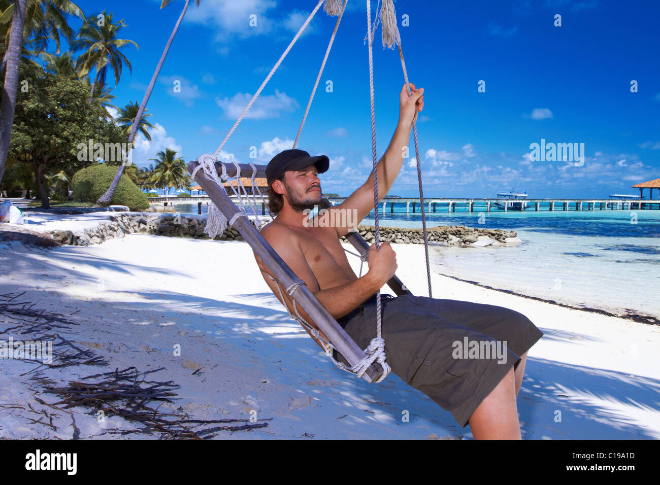 Handsome man resting near water at Maldives Stock Photo - Alamy