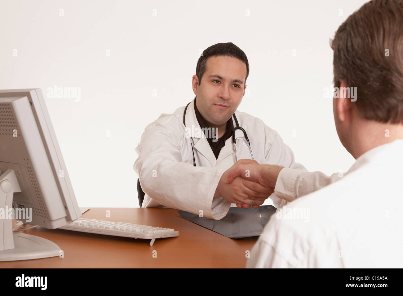 Doctor in consultation with a patient Stock Photo - Alamy