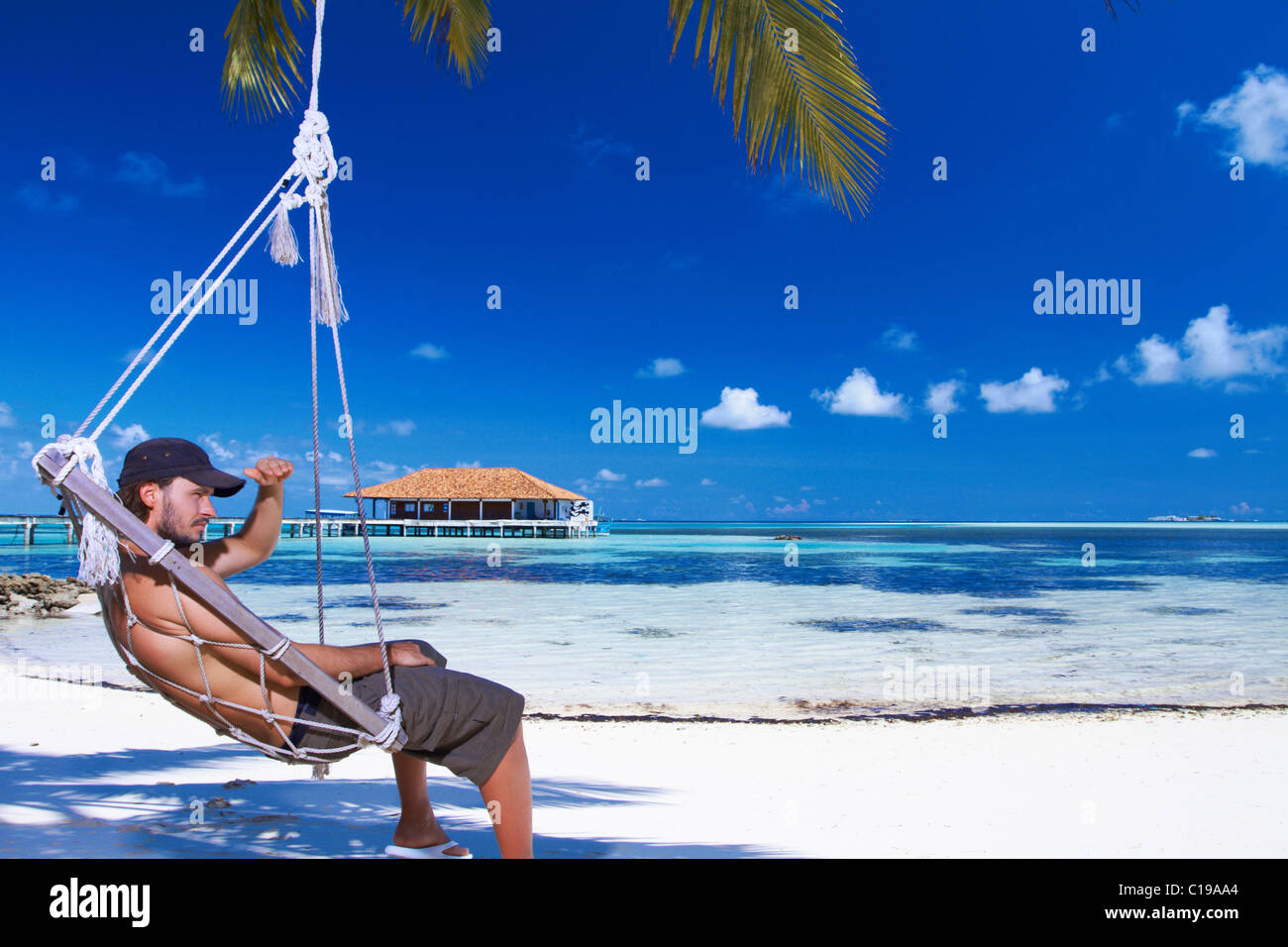Handsome man resting near water at Maldives Stock Photo - Alamy